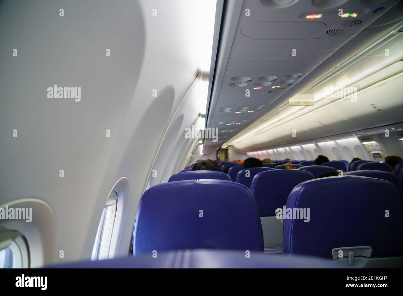 The inside view of the plane That shoots from the back with blue seats ...