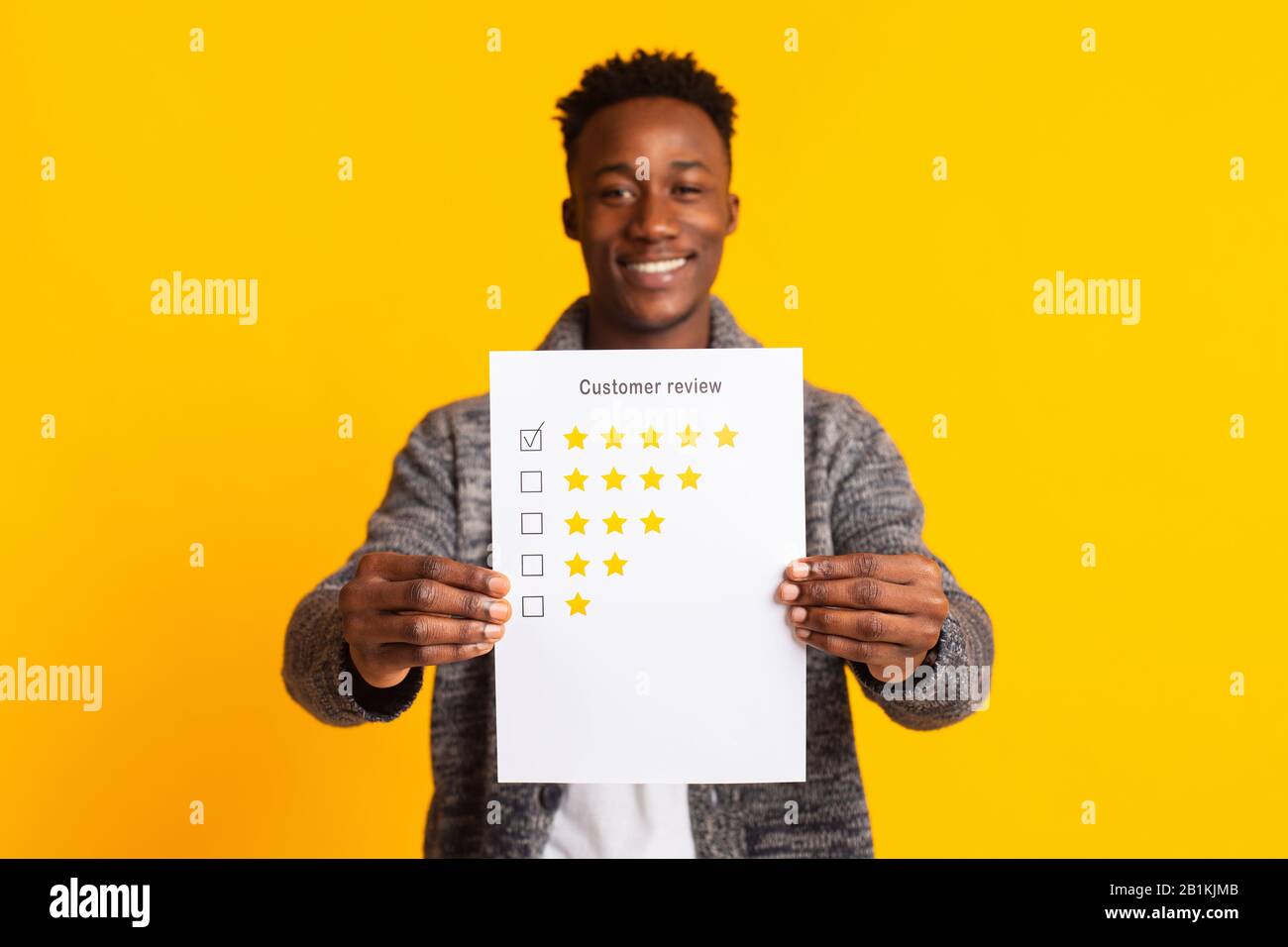 Young smiling african man is pointing on five stars rating Stock Photo ...
