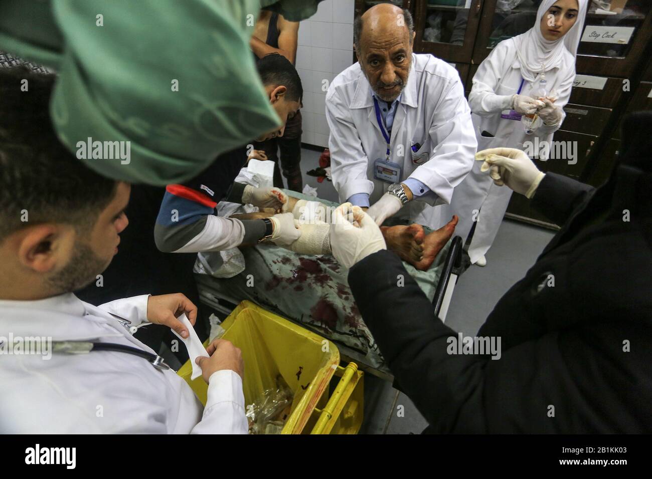 Paramedics treat an injured Palestinian at a hospital, After being shot ...