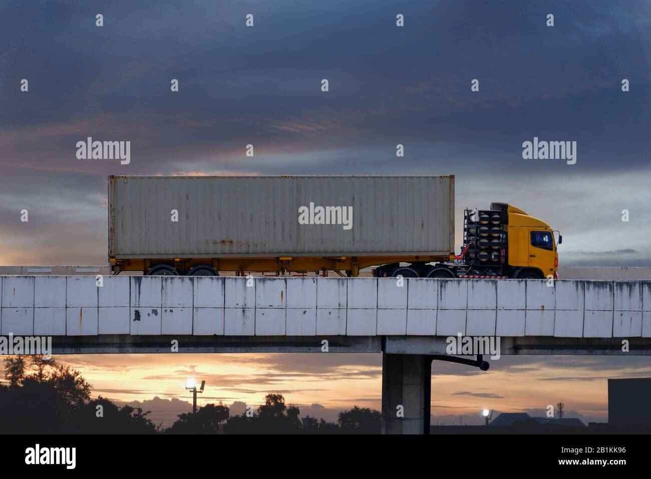 Container trucks run products on the bridge Stock Photo - Alamy