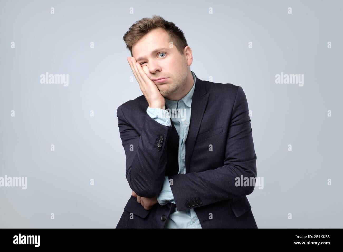 Sad young man looking bored feeling stressed after hard working day ...
