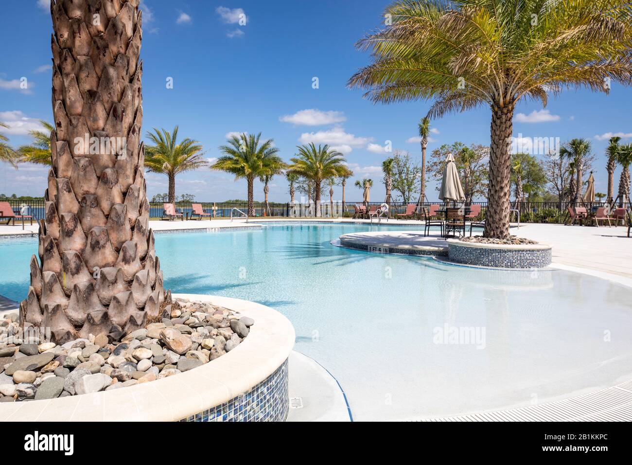 A community pool next to a recreational center at Babcock Ranch Florida ...