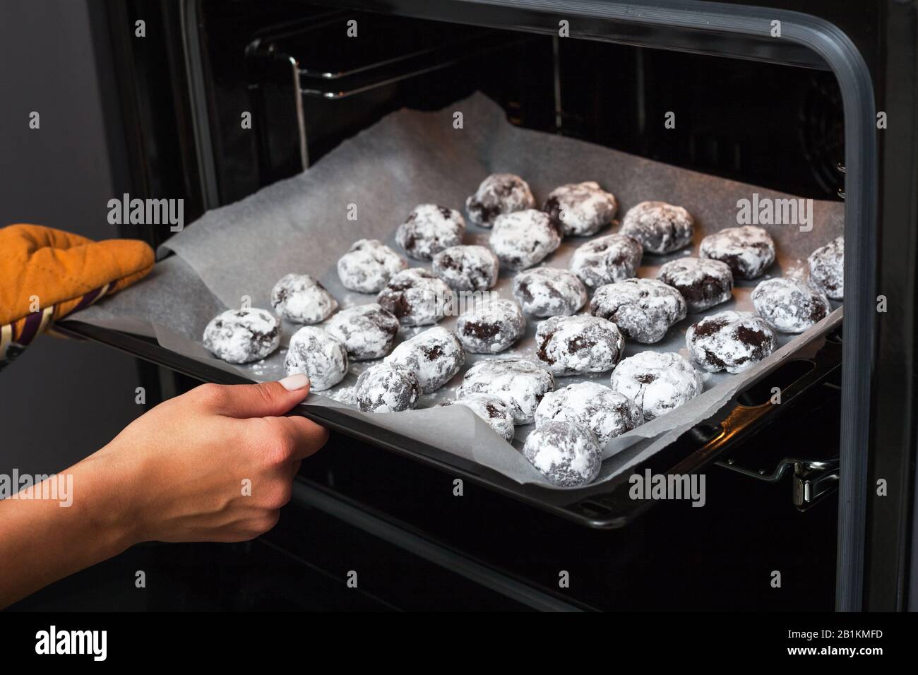 The process of baking brownie cookies. The photo shows female hands ...