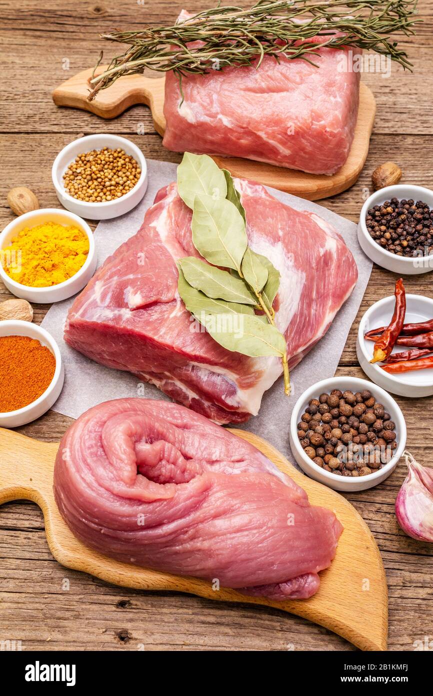 Assorted various fresh pork cuts. Raw meat with spices. Tenderloin ...
