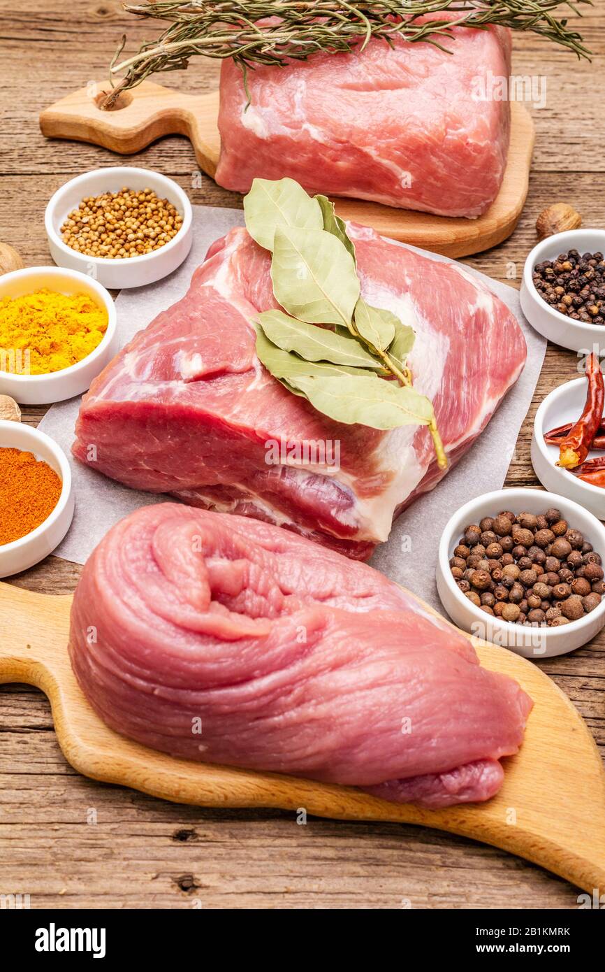 Assorted various fresh pork cuts. Raw meat with spices. Tenderloin ...