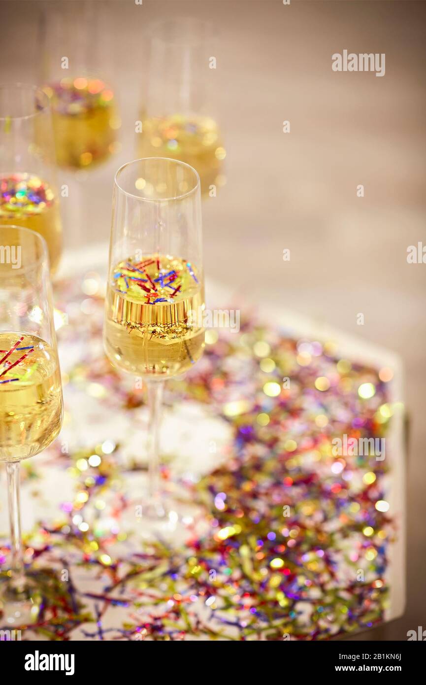 High angle of glasses of yellow fizzy alcohol drink on table among ...