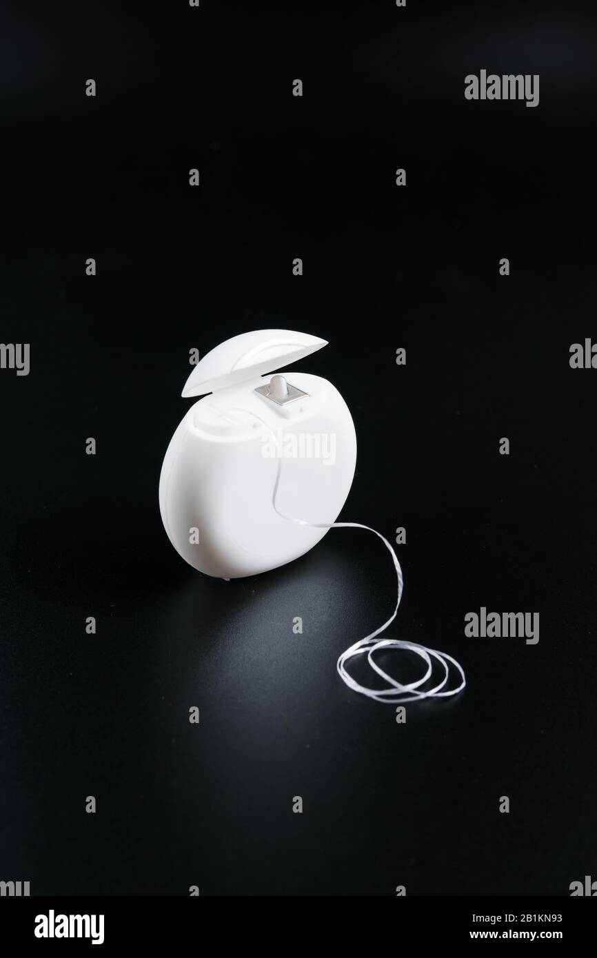 close-up, white dental floss on a black background Stock Photo - Alamy