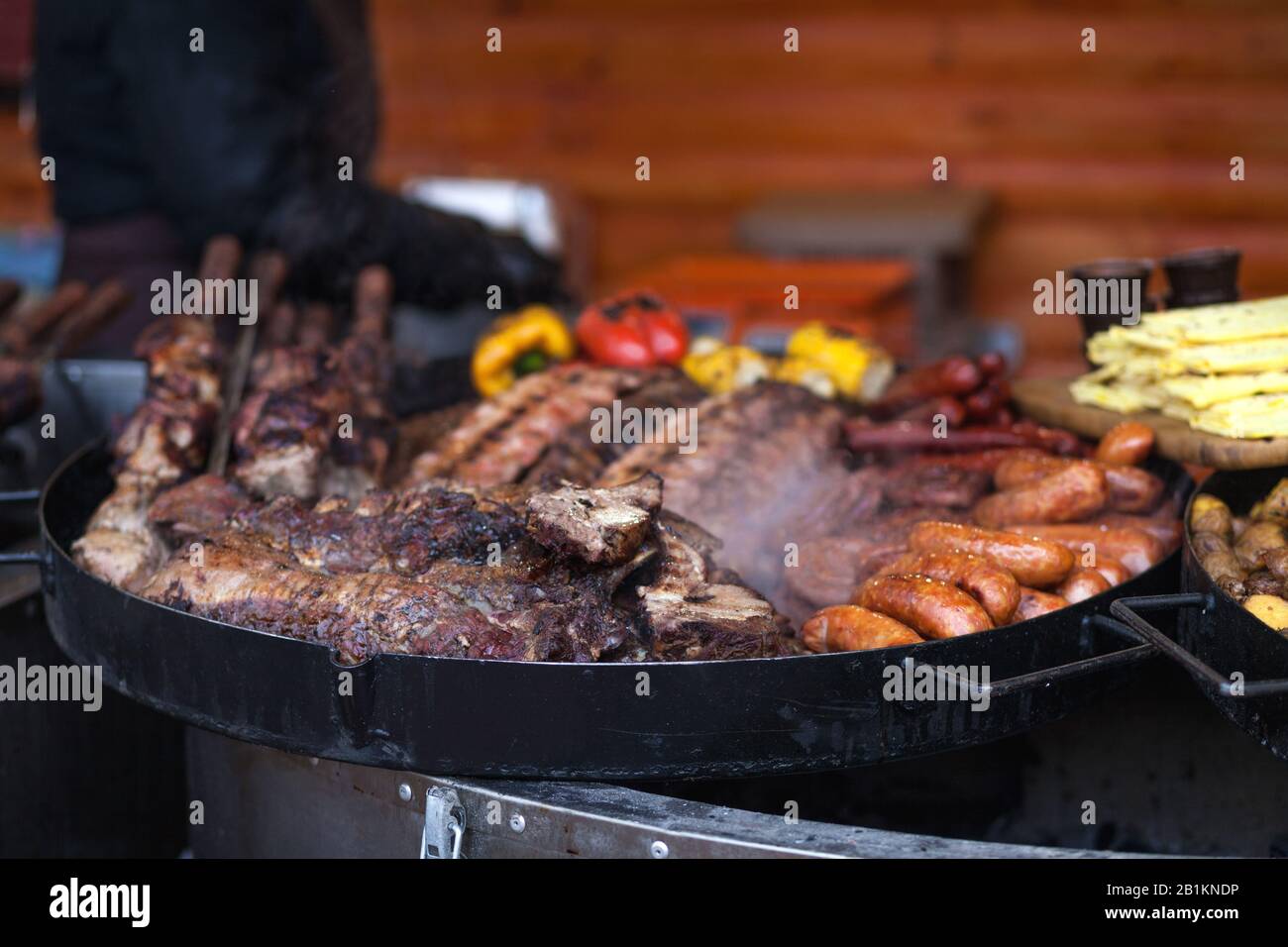 Fried street food. Meat with vegetables. Grill peppers, corn and ...