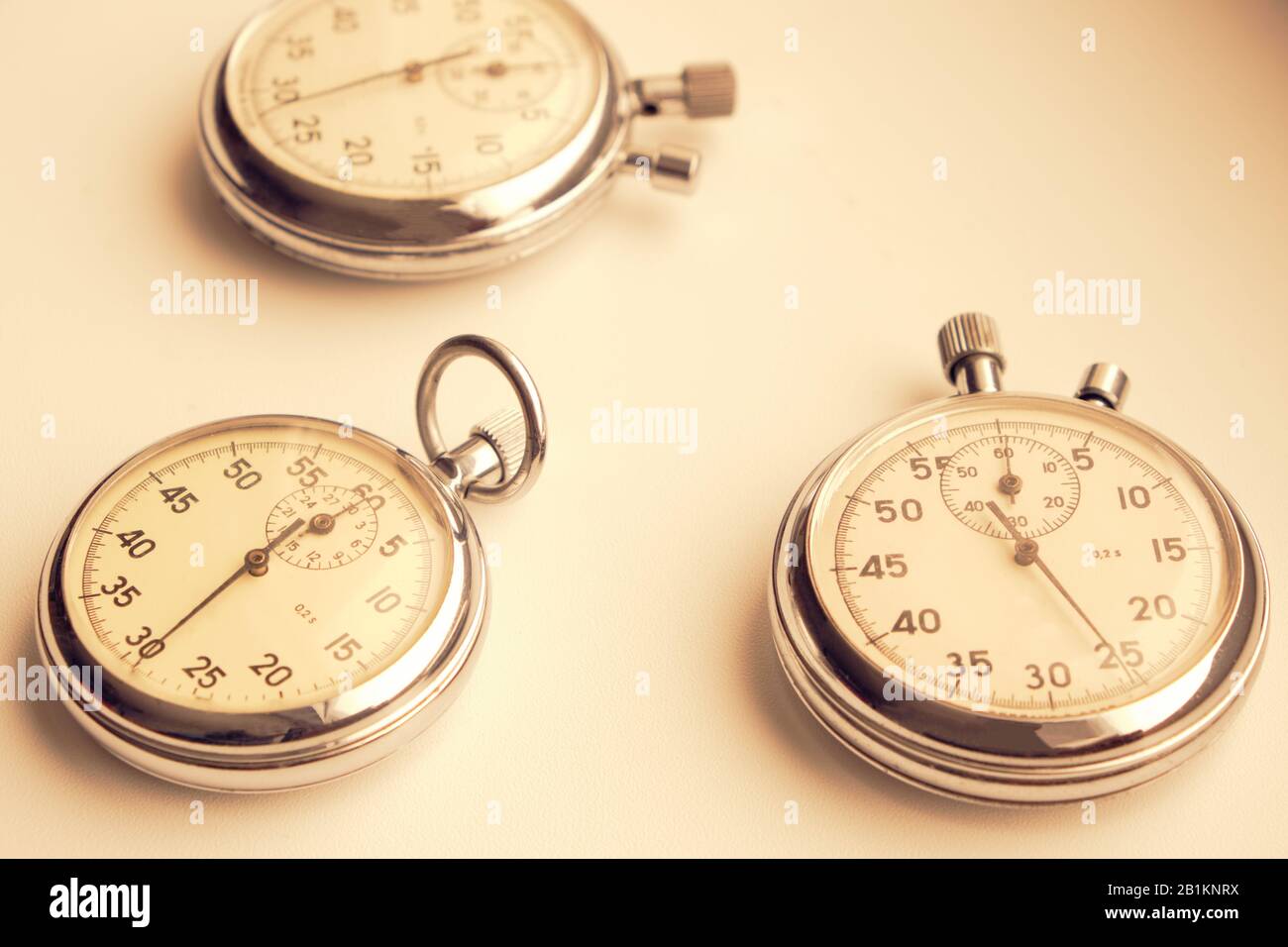 Three retro mechanical stopwatches on a light background Stock Photo ...