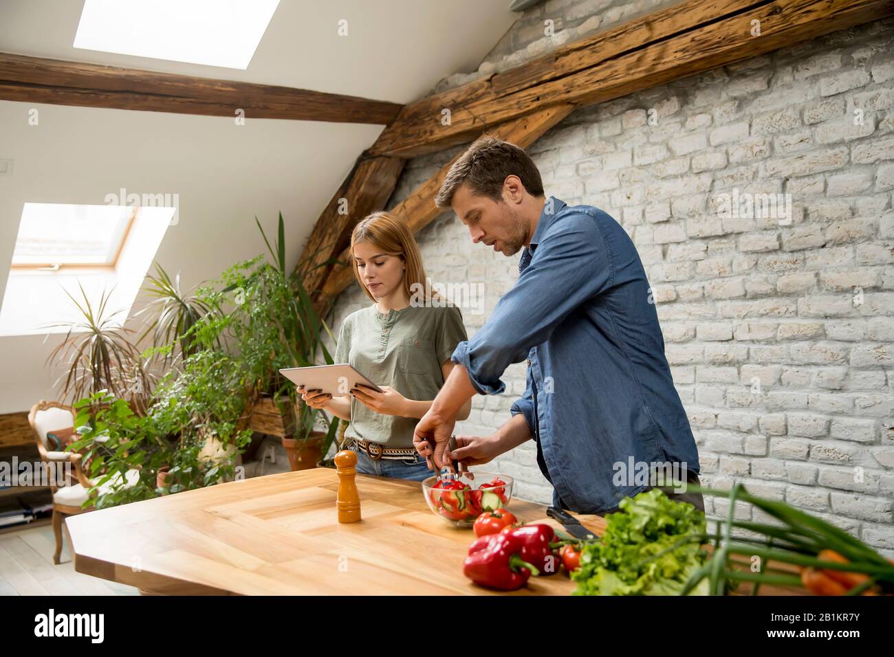 View at couple cooking in the modern kitchen Stock Photo - Alamy