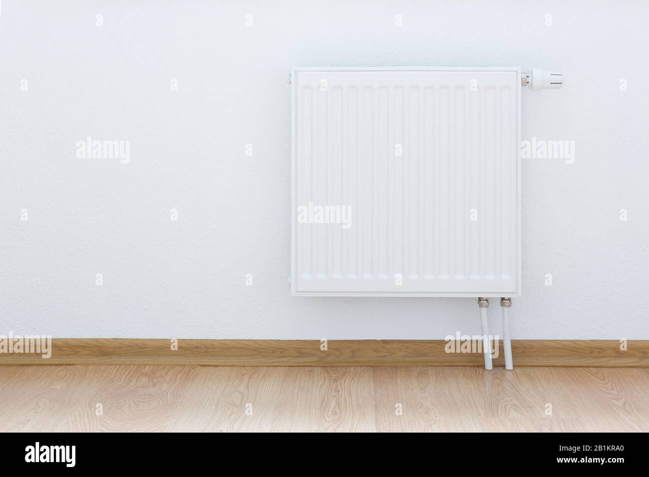 heating radiator against white wall Stock Photo - Alamy