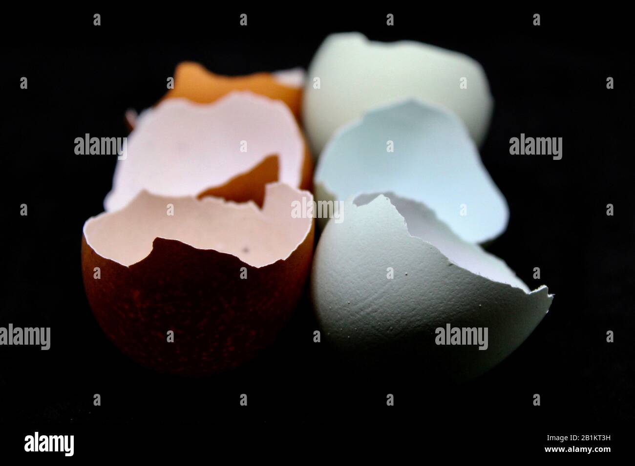 Three brown and three blue broken eggshells Stock Photo - Alamy