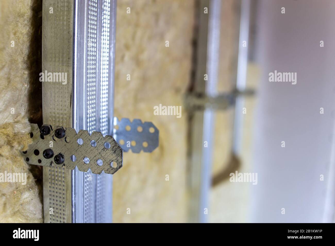 Wall of a room under renovation with mineral rock wool insulation and ...
