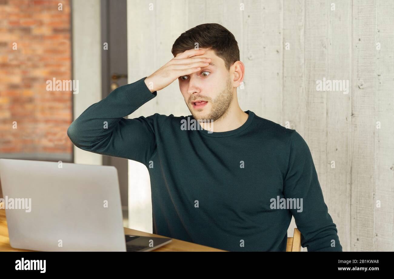 Overworked Employee Looking At Laptop In Shock Sitting In Office Stock ...
