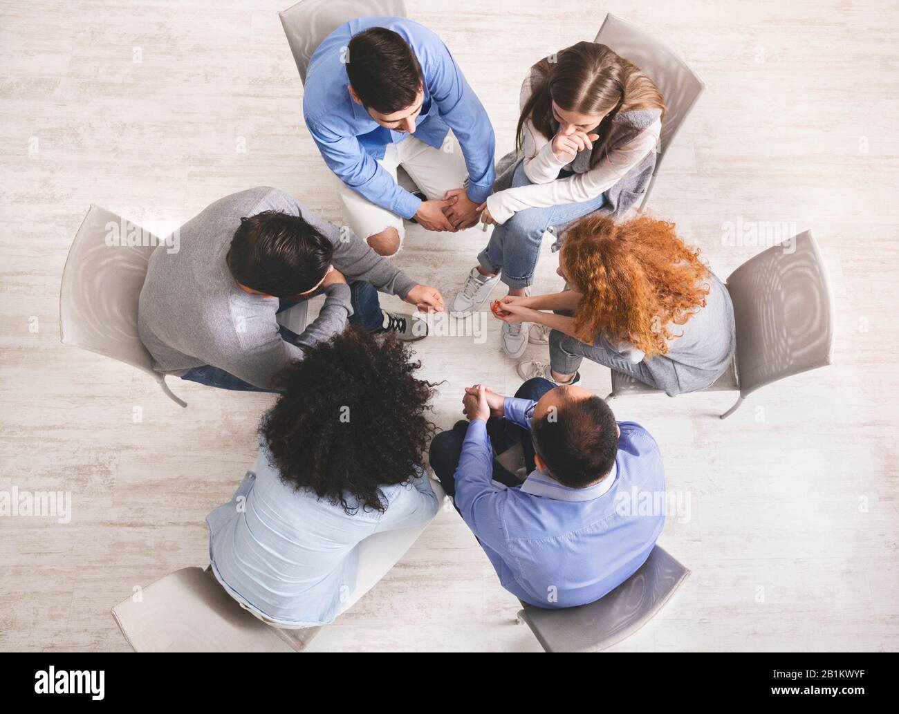 Group of people sitting in circle, dicussing problems during therapy ...