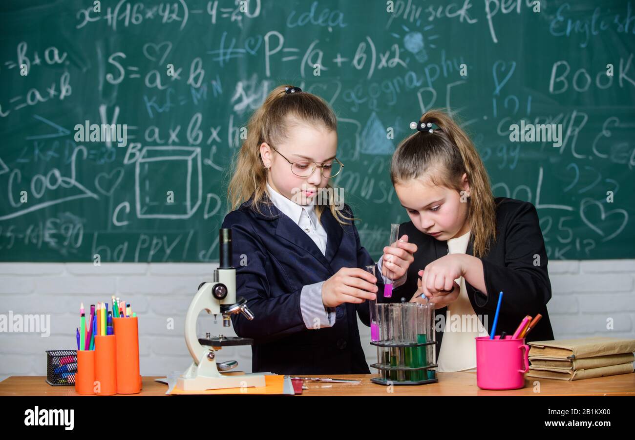 Chemistry research in laboratory. Little girls in school lab. Teamwork ...