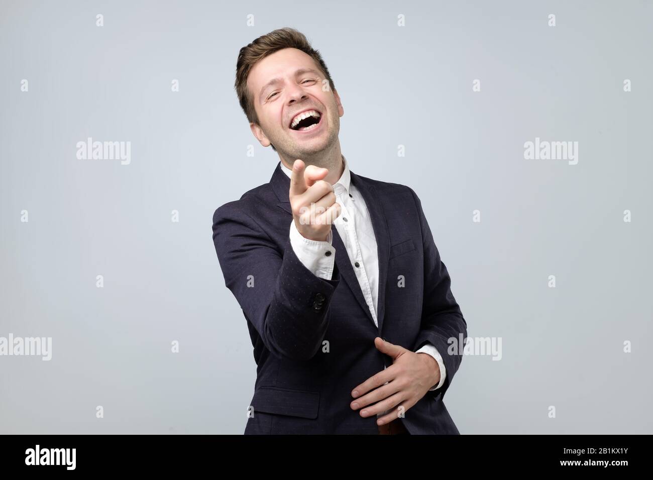 Laughing hispanic guy showing hi-res stock photography and images - Alamy