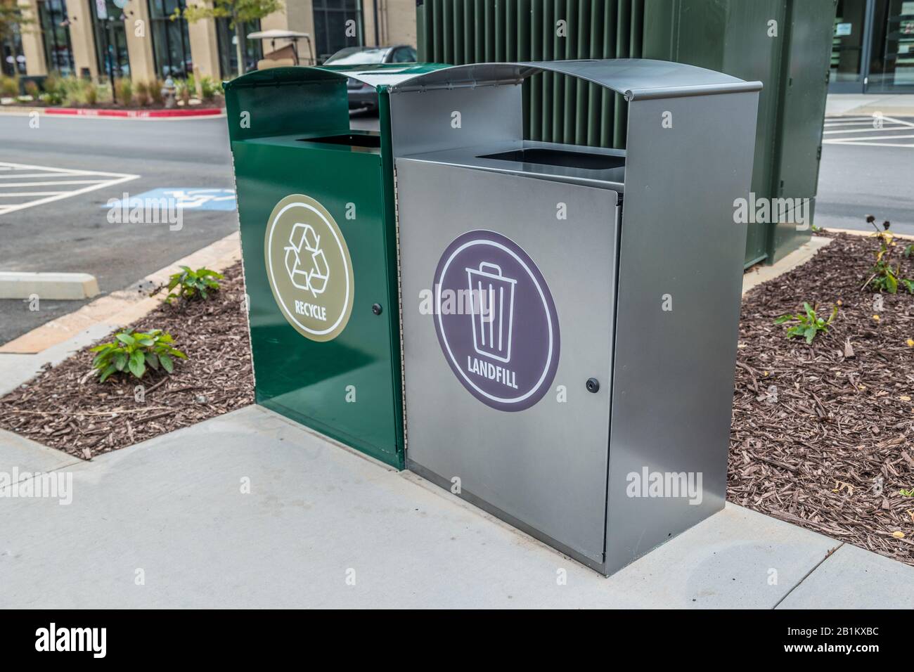 Two side by side metal garbage cans one for recyclables and the other ...
