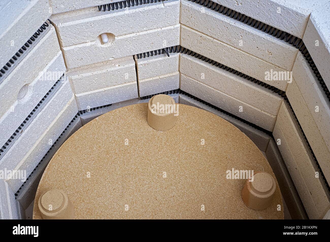 view into a kiln for firing ceramics with heating coils, temperature ...