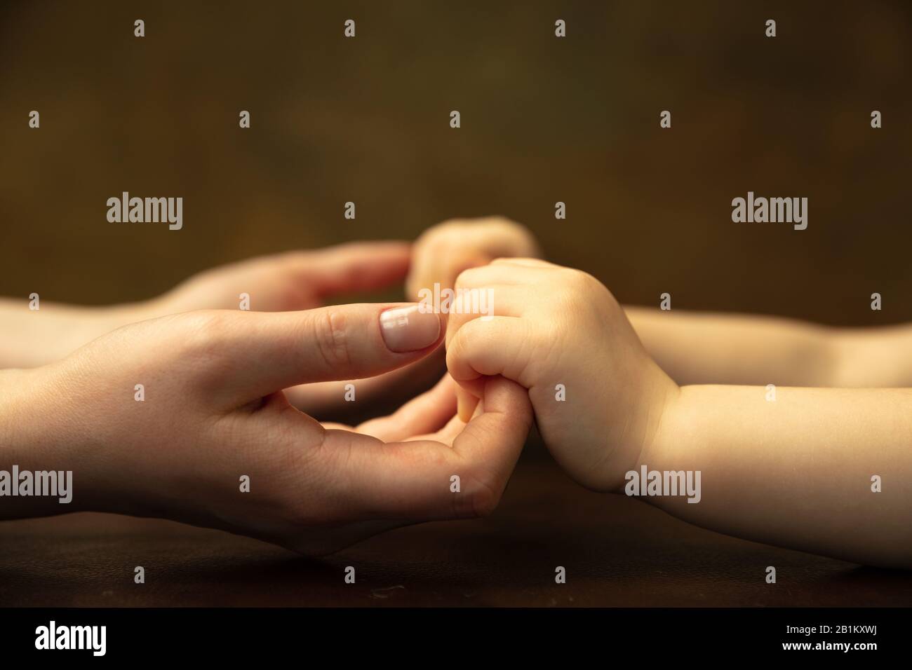 Holding hands, clapping like friends. Close up shot of female and kid's ...