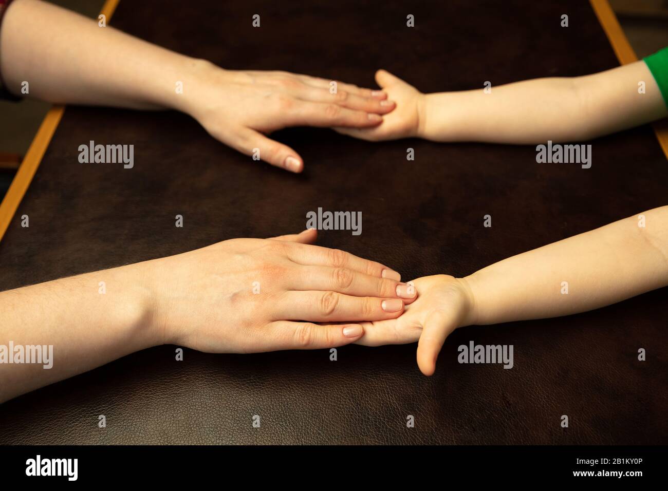 Holding hands, clapping like friends. Close up shot of female and kid's ...