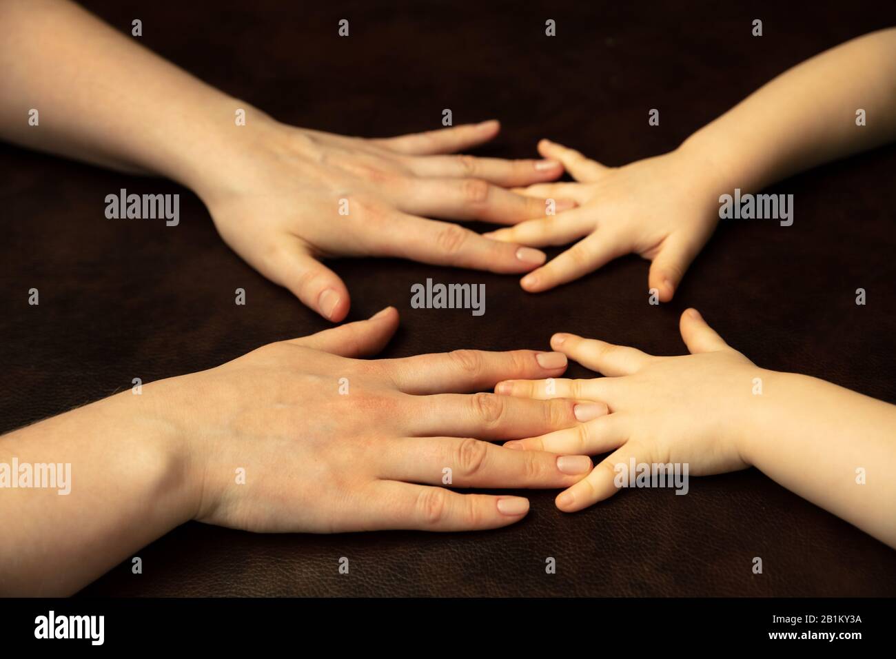 Holding hands, clapping like friends. Close up shot of female and kid's ...