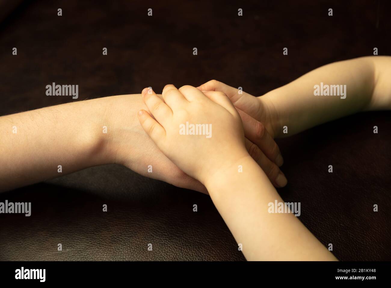 Holding hands, clapping like friends. Close up shot of female and kid's ...