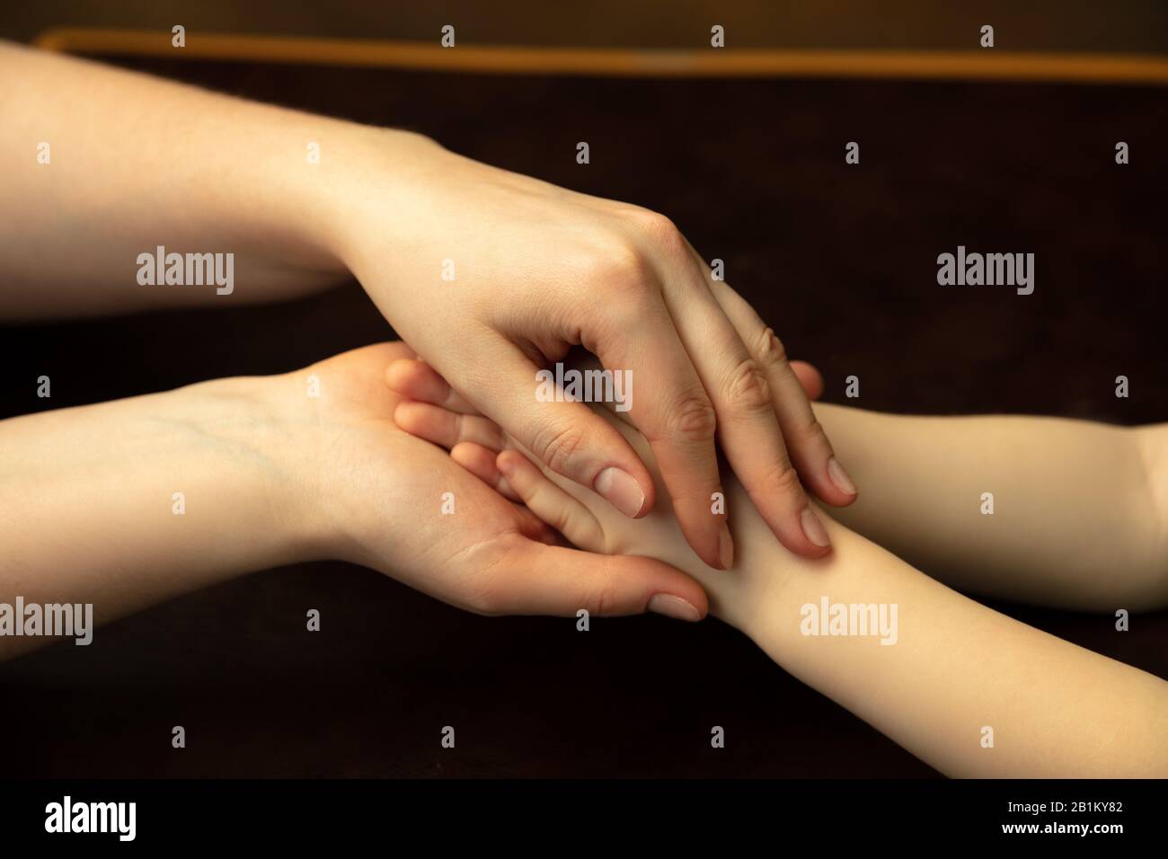 Holding hands, clapping like friends. Close up shot of female and kid's ...