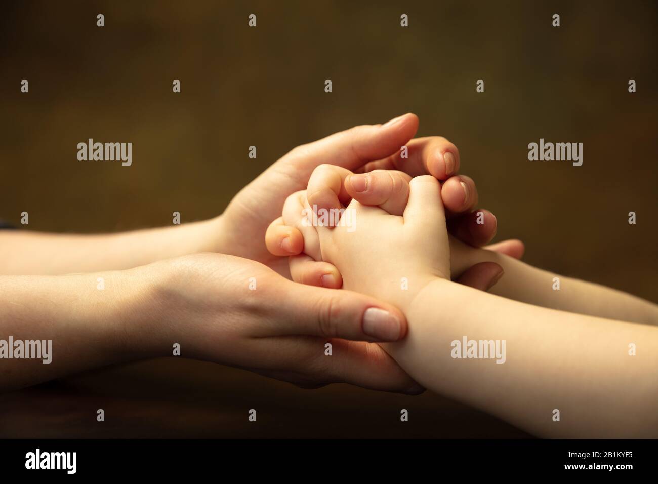 Holding hands, clapping like friends. Close up shot of female and kid's ...