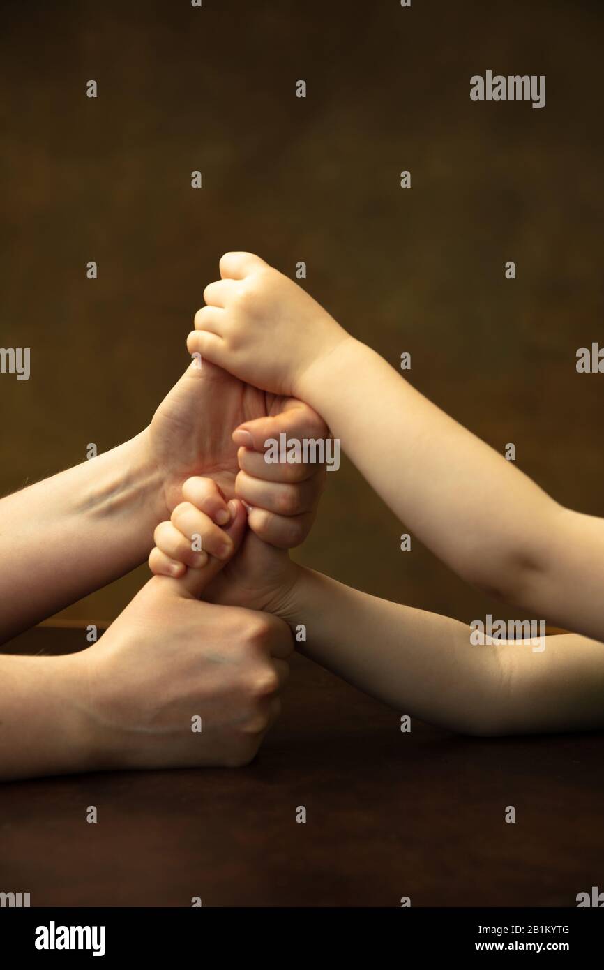Holding hands, clapping like friends. Close up shot of female and kid's ...