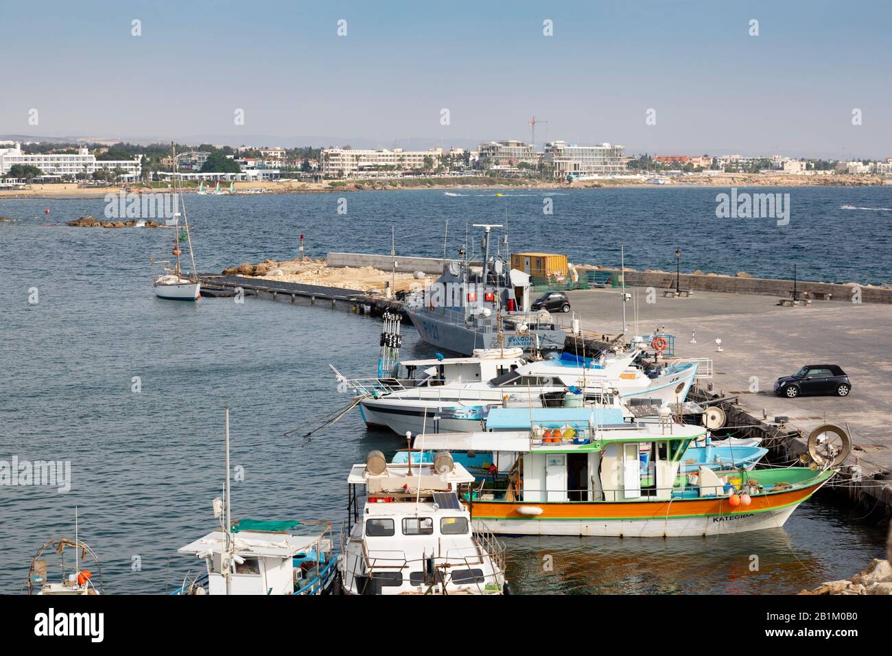 Traditional Cypriot fishing boats alongside modern luxury yachts moored ...