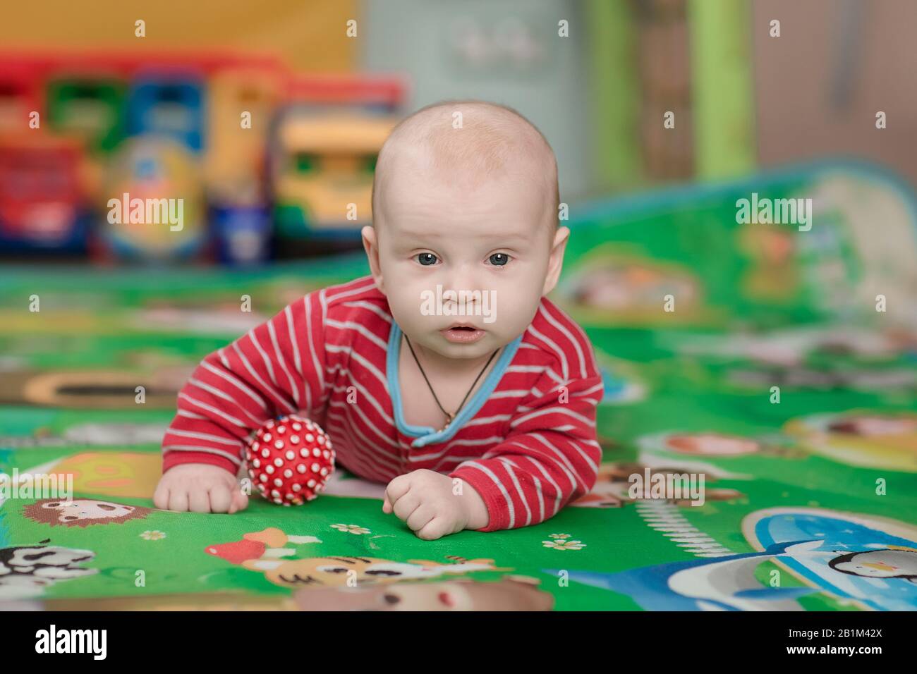 Cute little baby boy trying to lie on belly and crawling Stock Photo ...