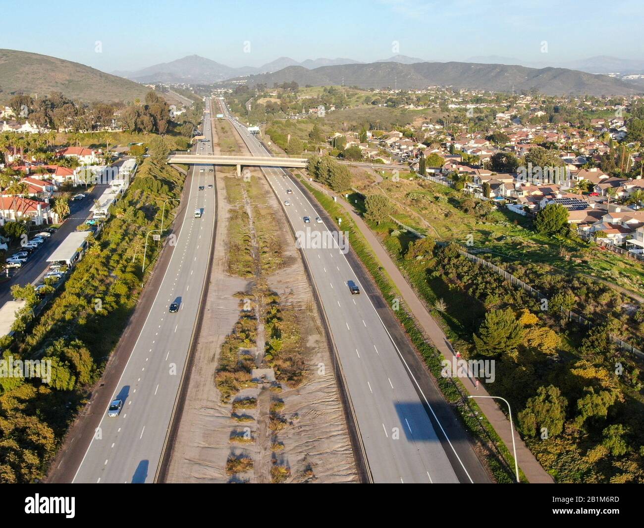 Aerial view of highway surrounded by villa in suburb. Intersection city ...