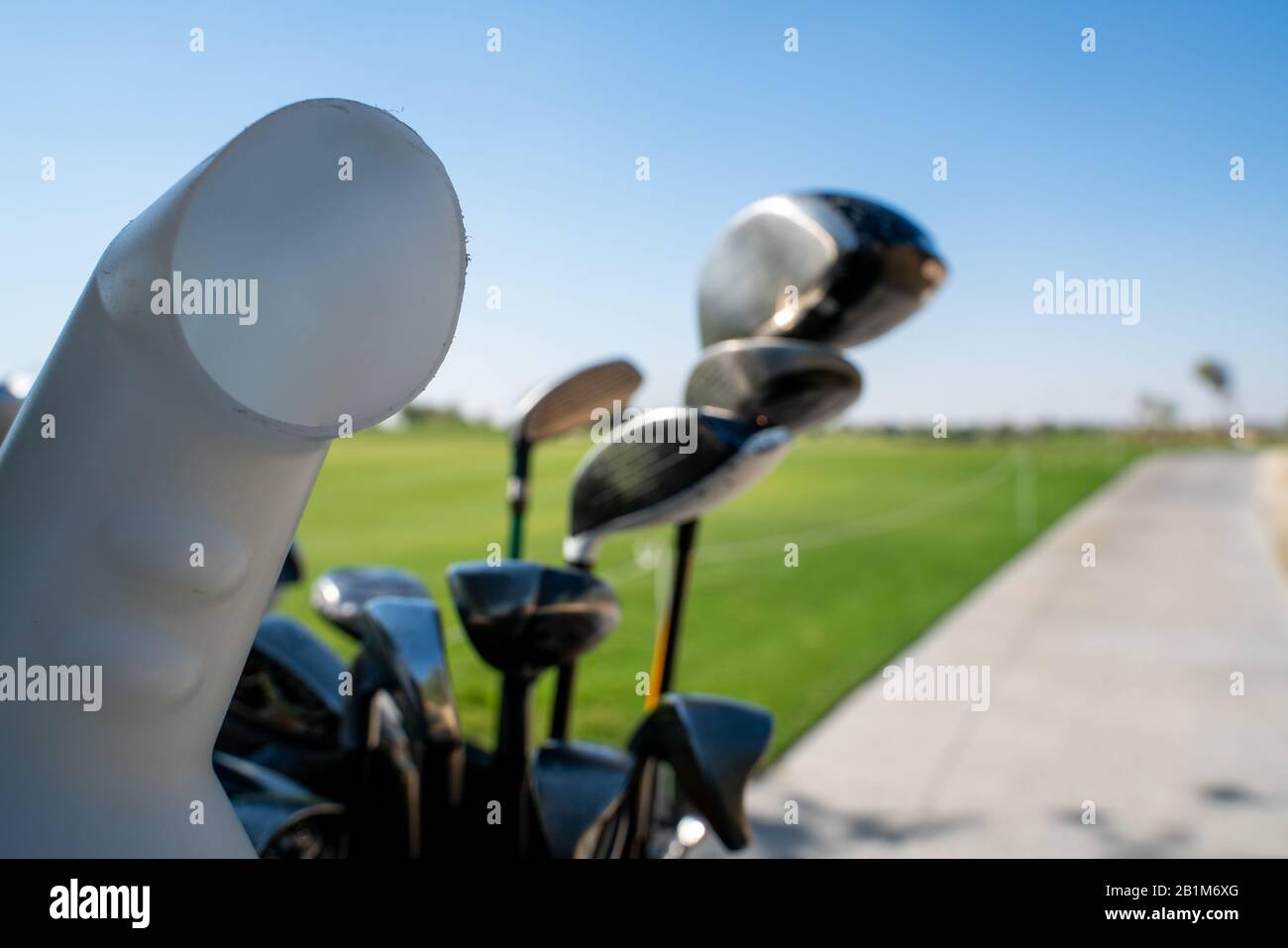 Background image of multiple golf sticks on the behind of a golf cart ...