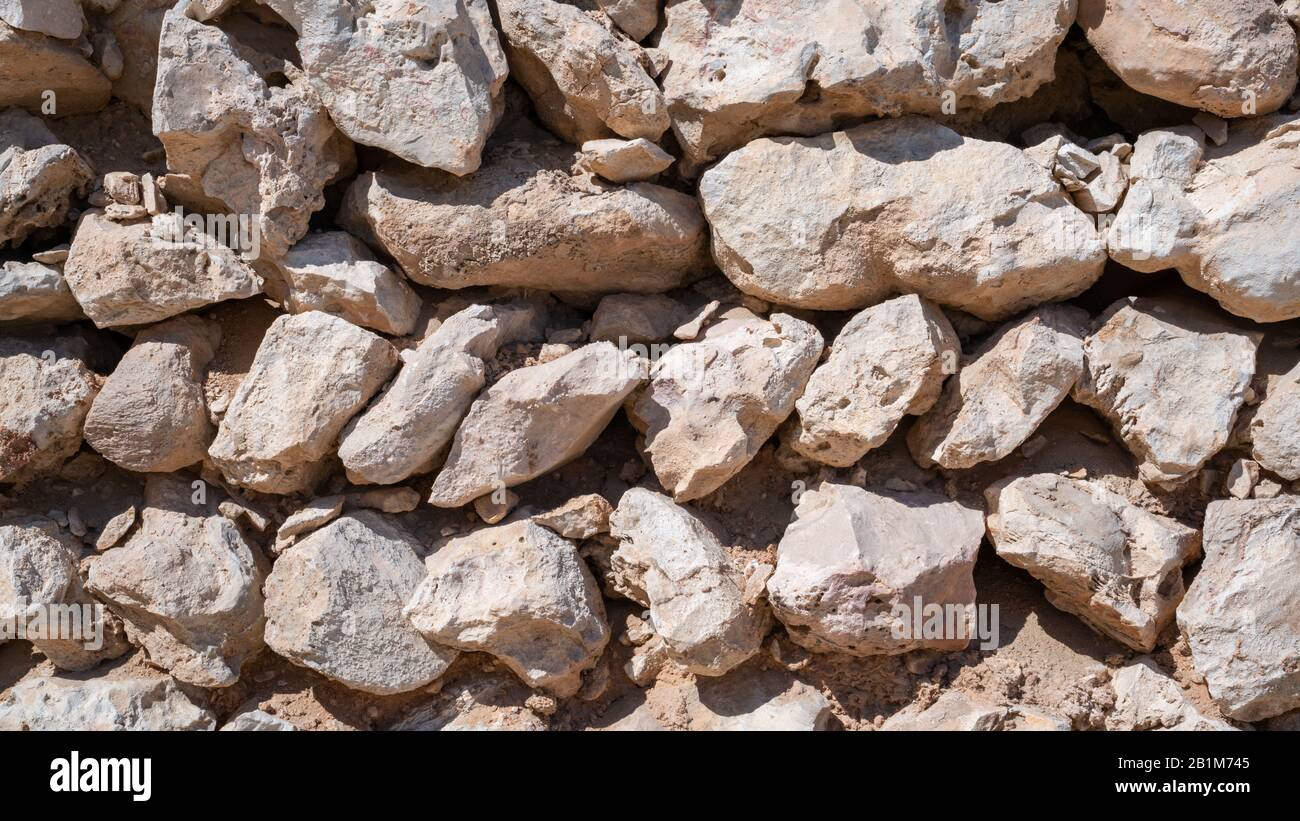 Background image of traditional arab stone wall with multiple stones ...