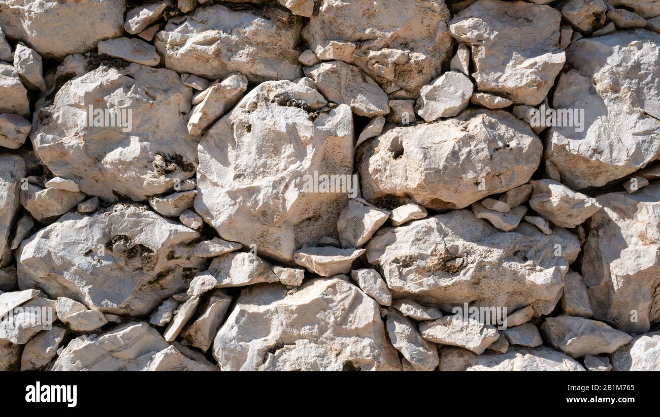 Background image of traditional arab stone wall with multiple stones ...