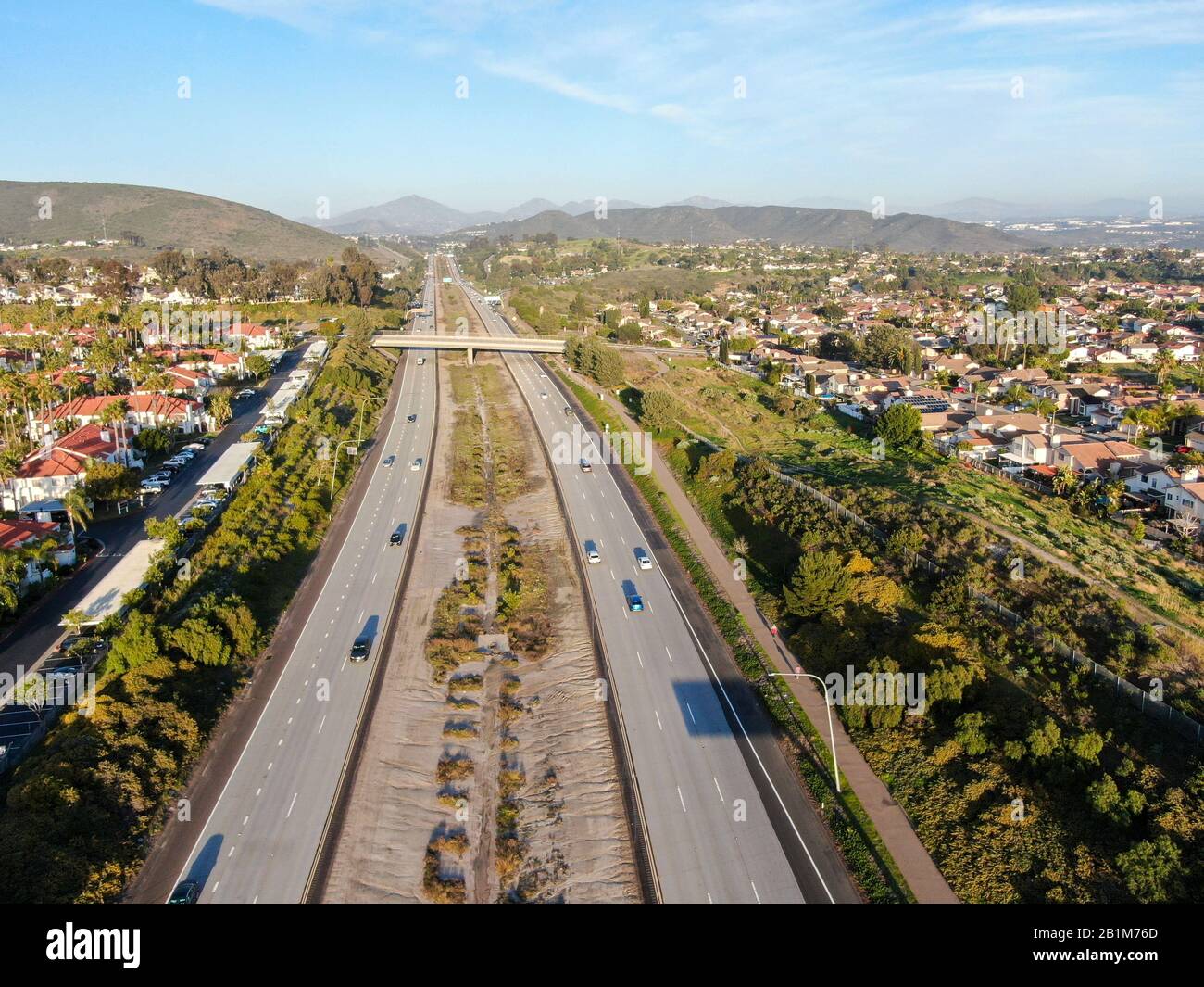 Aerial view of highway surrounded by villa in suburb. Intersection city ...