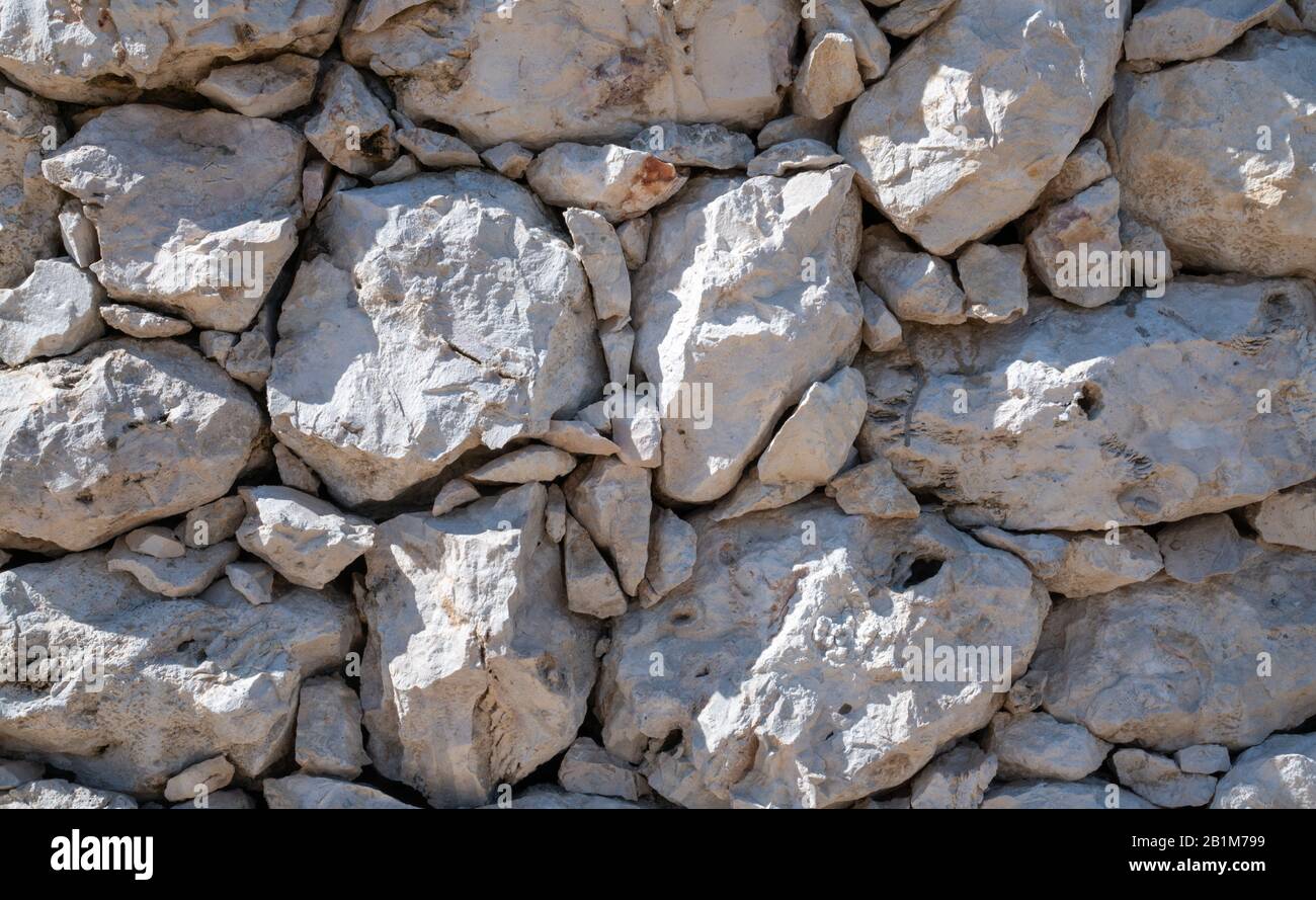 Background image of traditional arab stone wall with multiple stones ...
