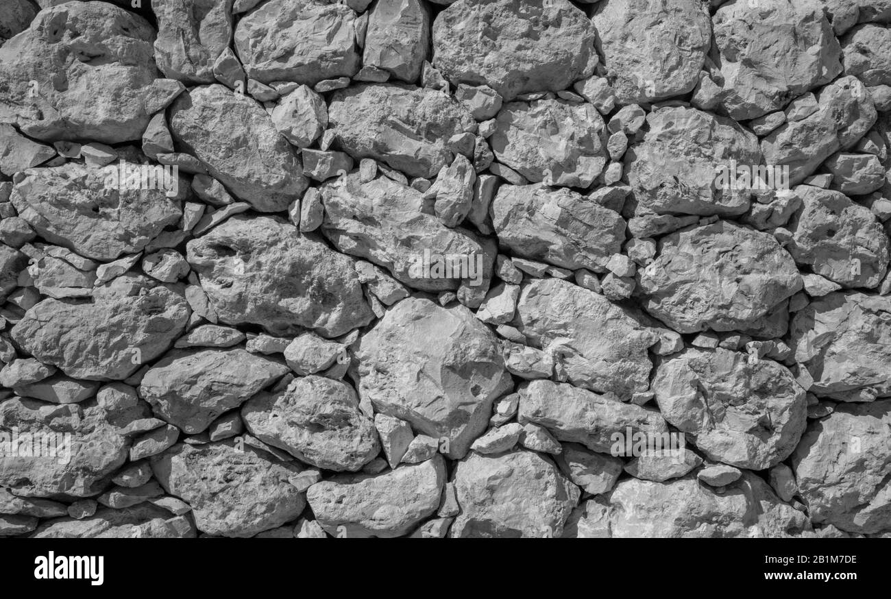 Background image of traditional arab stone wall with multiple stones ...