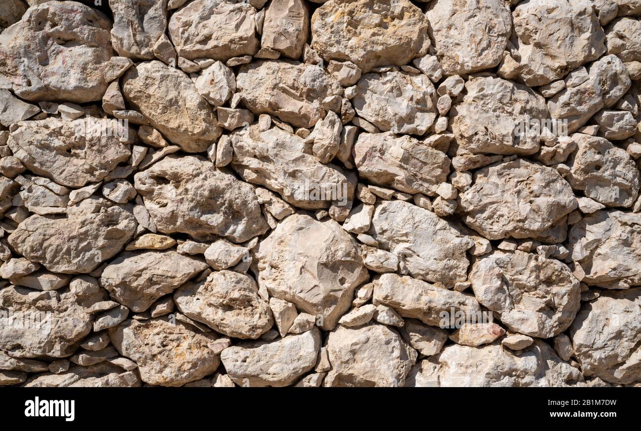 Background image of traditional arab stone wall with multiple stones Stock Photo - Alamy