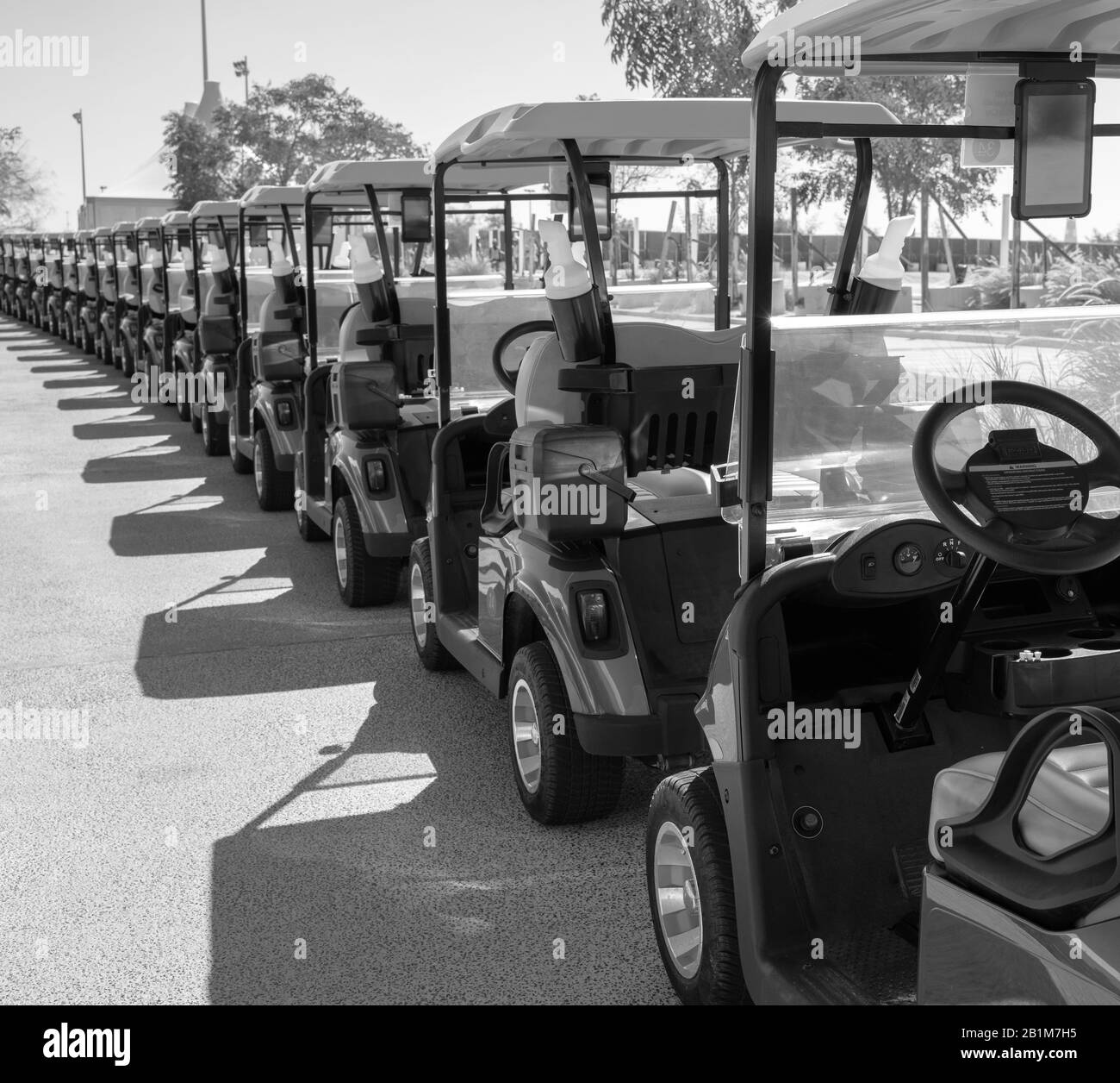 Background image of multiple golf carts parked in order Stock Photo - Alamy