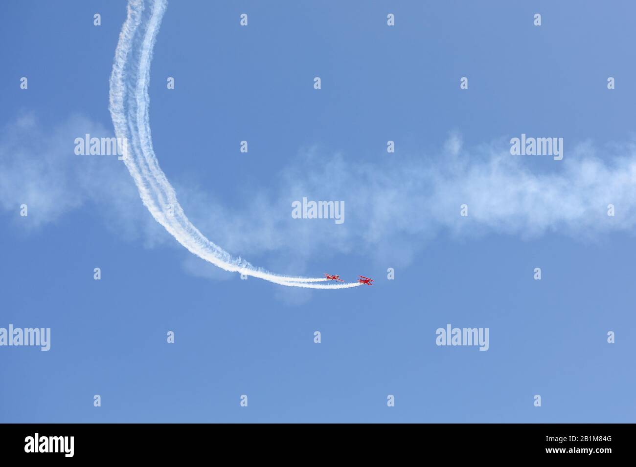 Plane doing acrobatic formation in the blue sky. Airplanes on airshow ...