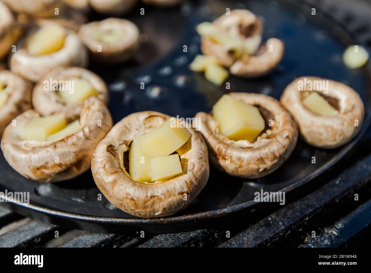 White mushrooms champignon filled with cheese preparing for barbecue ...