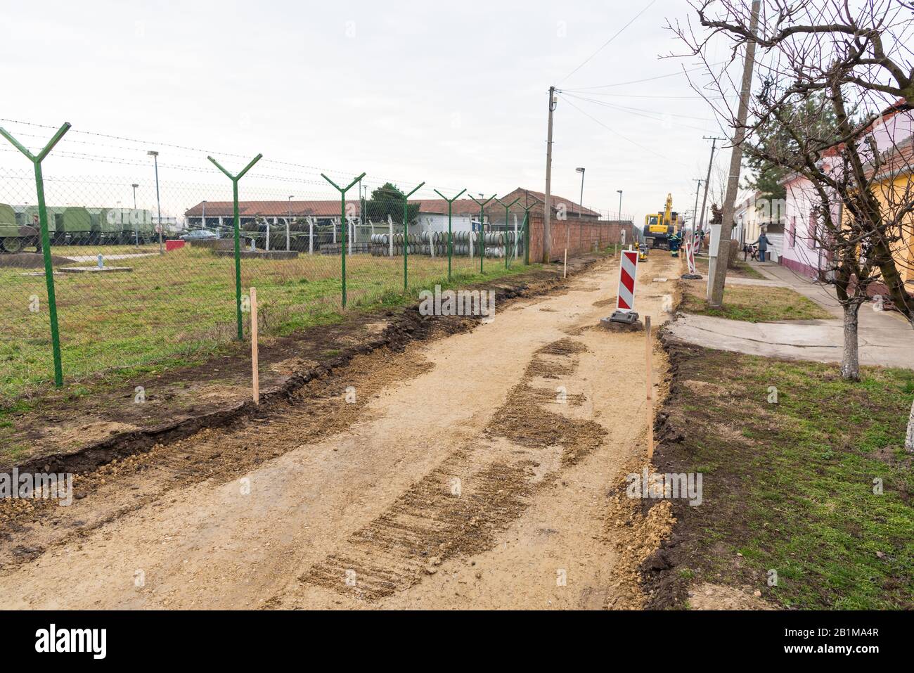 Workers with machinery preparing the road for new asphalt Stock Photo ...