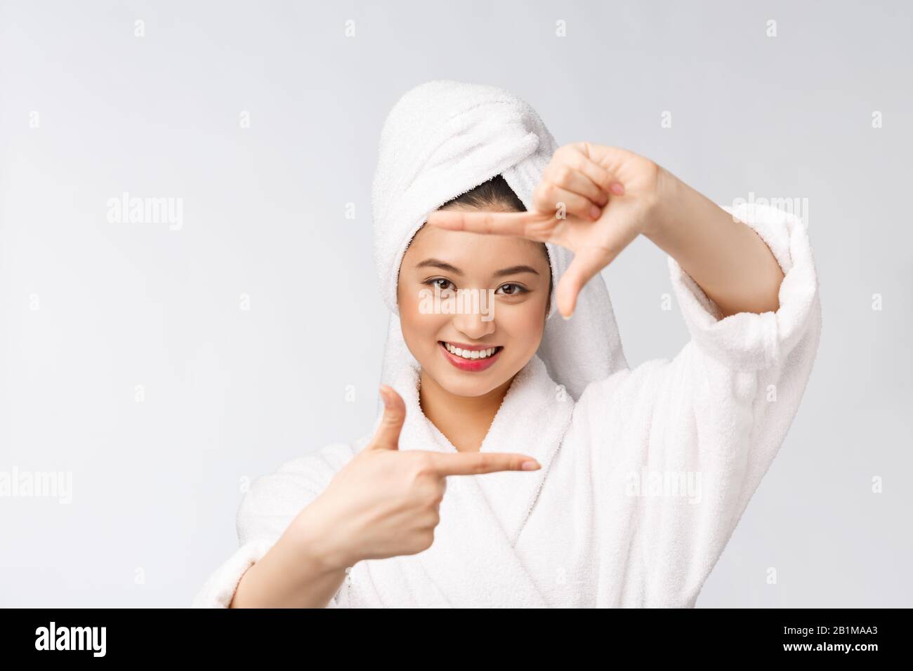 Beautiful Woman face and she making frame with hands with health skin ...