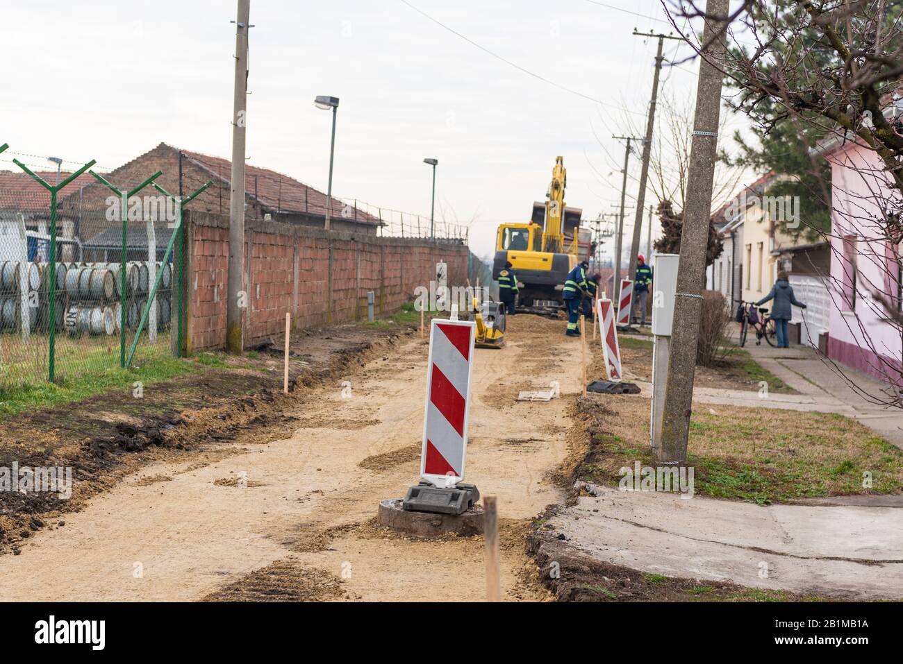 Workers with machinery preparing the road for new asphalt Stock Photo ...