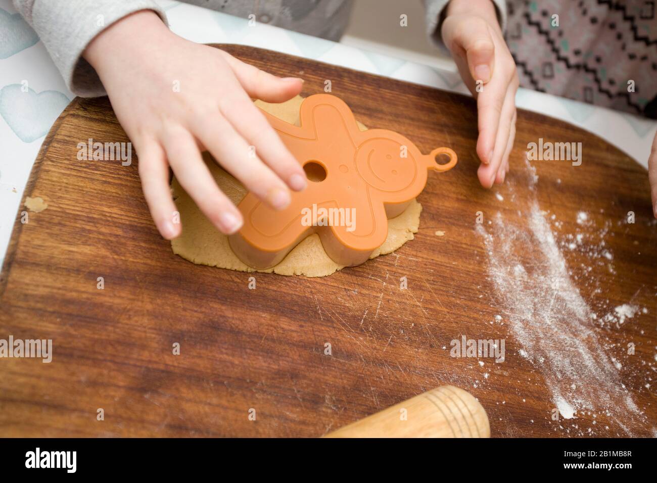 Child using cutting to make gingerbread men Stock Photo - Alamy