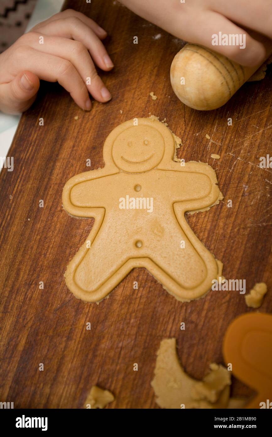 Child making gingerbread men Stock Photo - Alamy