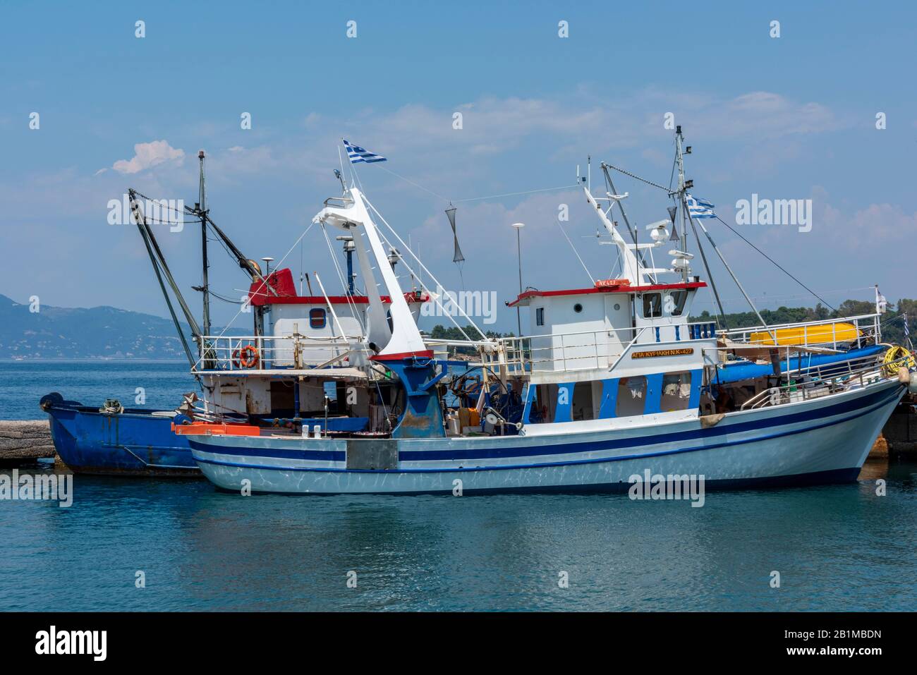 Inshore fishing boats or trawlers alongside in the Greek port of ...