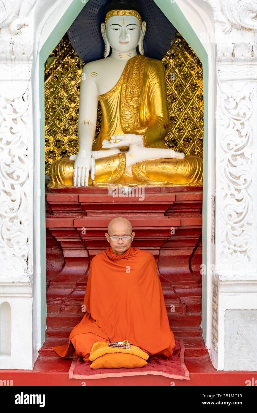 Seated monk at Shwedagon Pagoda, Yangon, Myanmar Stock Photo - Alamy